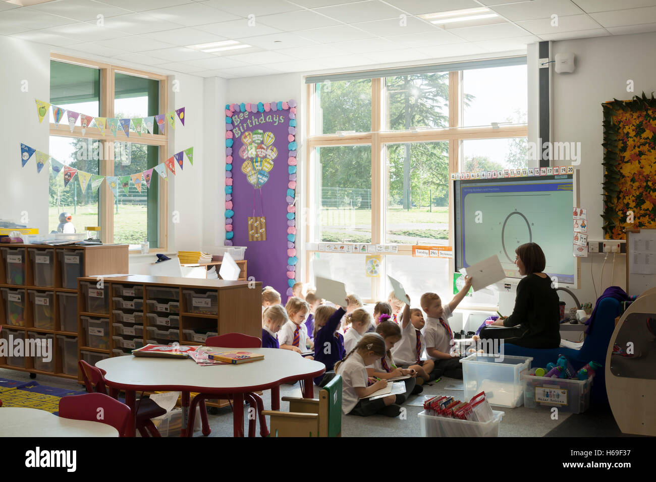 Angled view of classroom with pupils studying. Tiger Primary School ...