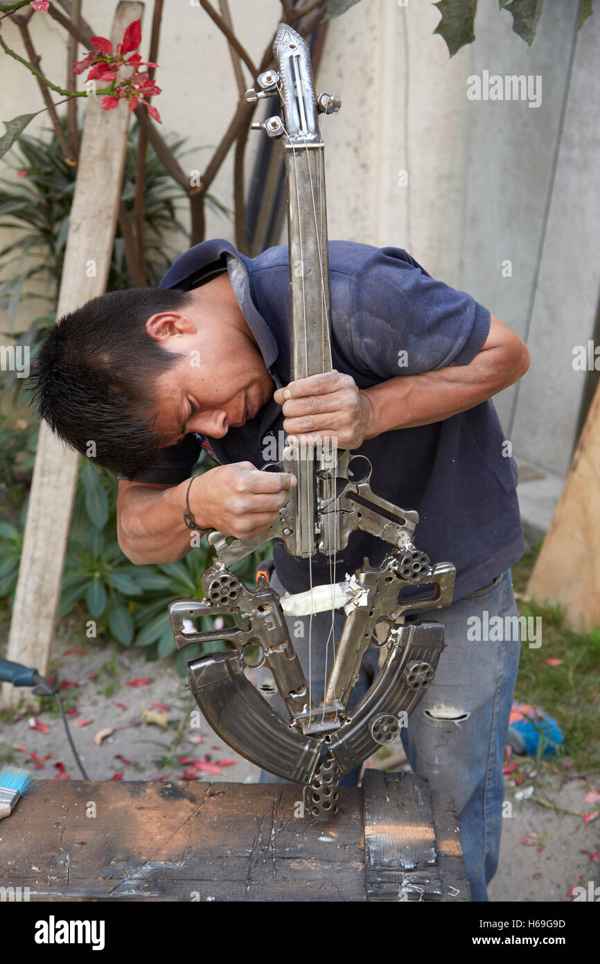 Studio worker producing machine gun guitar. Pedro Reyes House, Mexico ...