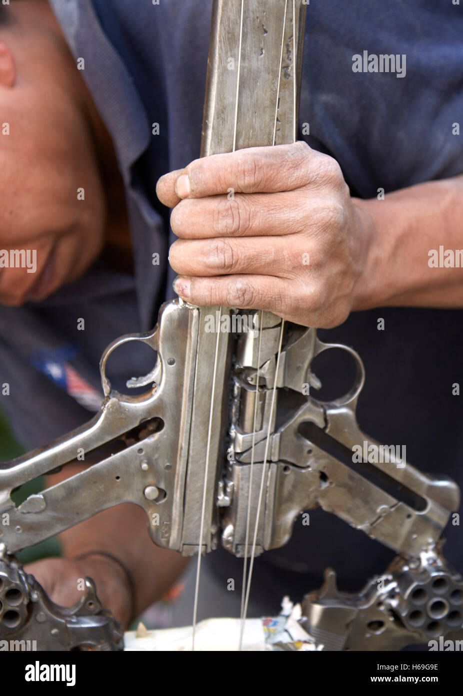 Studio worker producing machine gun guitar. Pedro Reyes House, Mexico ...