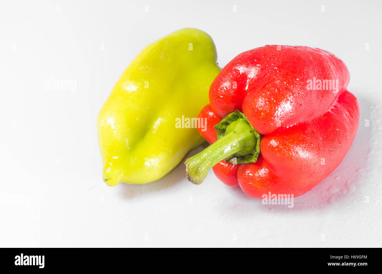 Two peppers green and red Stock Photo - Alamy