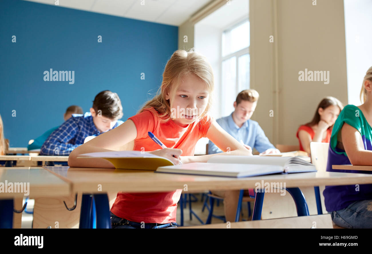 student girl with book writing school test Stock Photo - Alamy