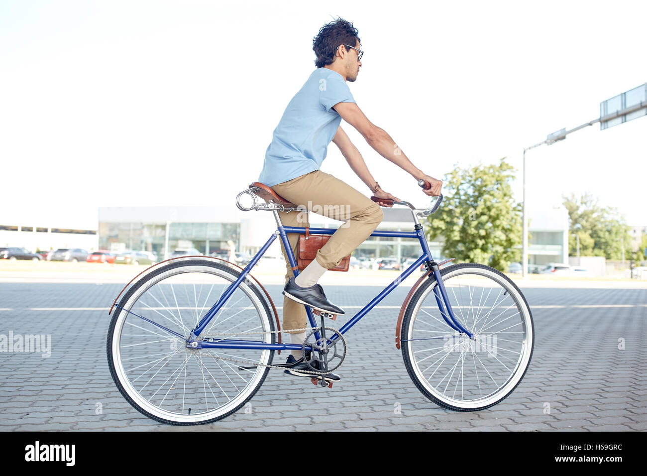 young hipster man riding fixed gear bike Stock Photo - Alamy