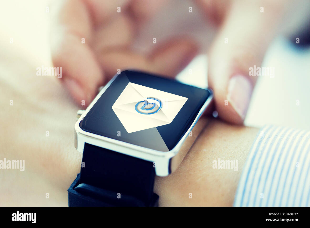 close up of hands with email icon on smartwatch Stock Photo - Alamy