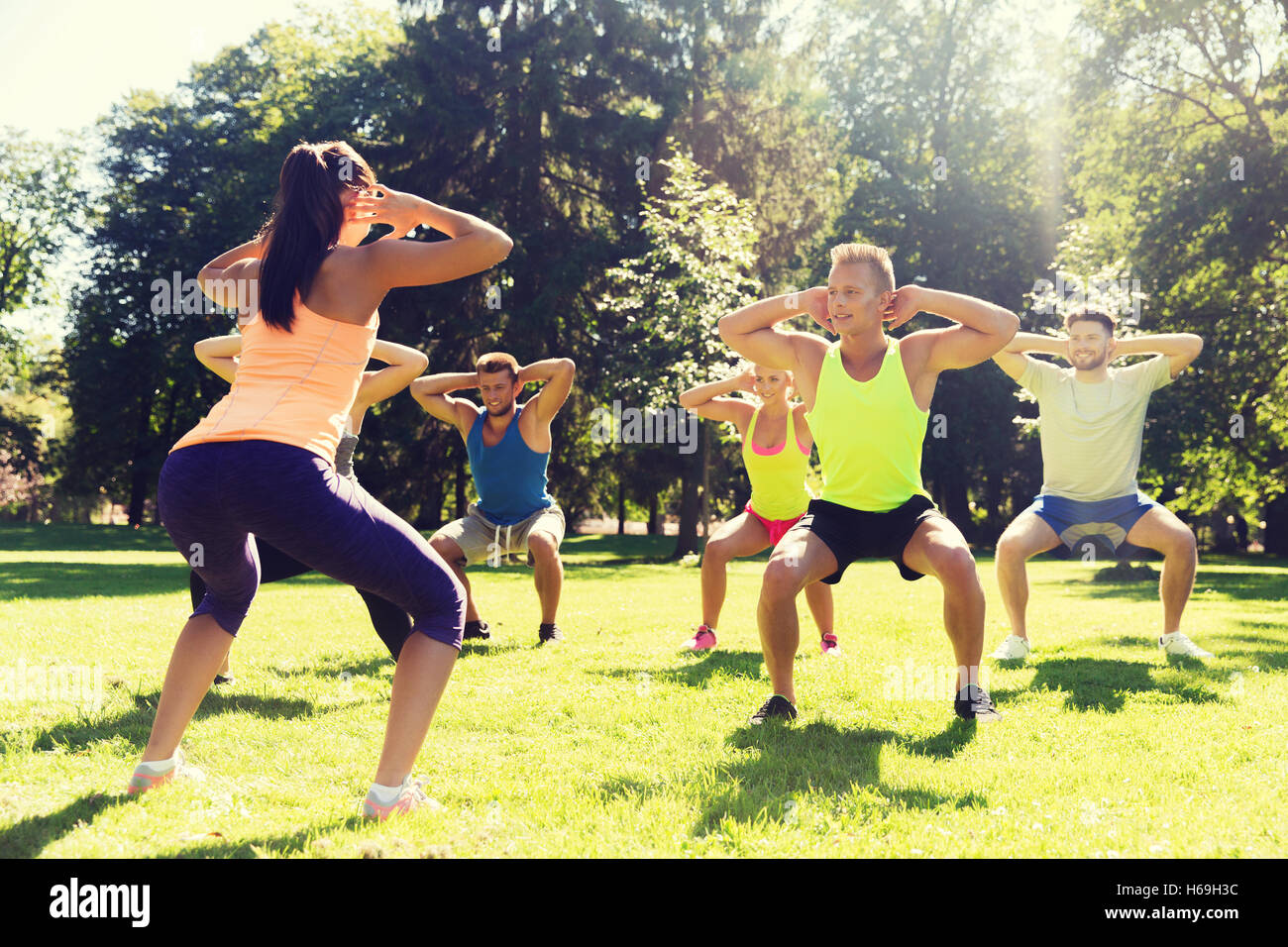 group of friends or sportsmen exercising outdoors Stock Photo - Alamy