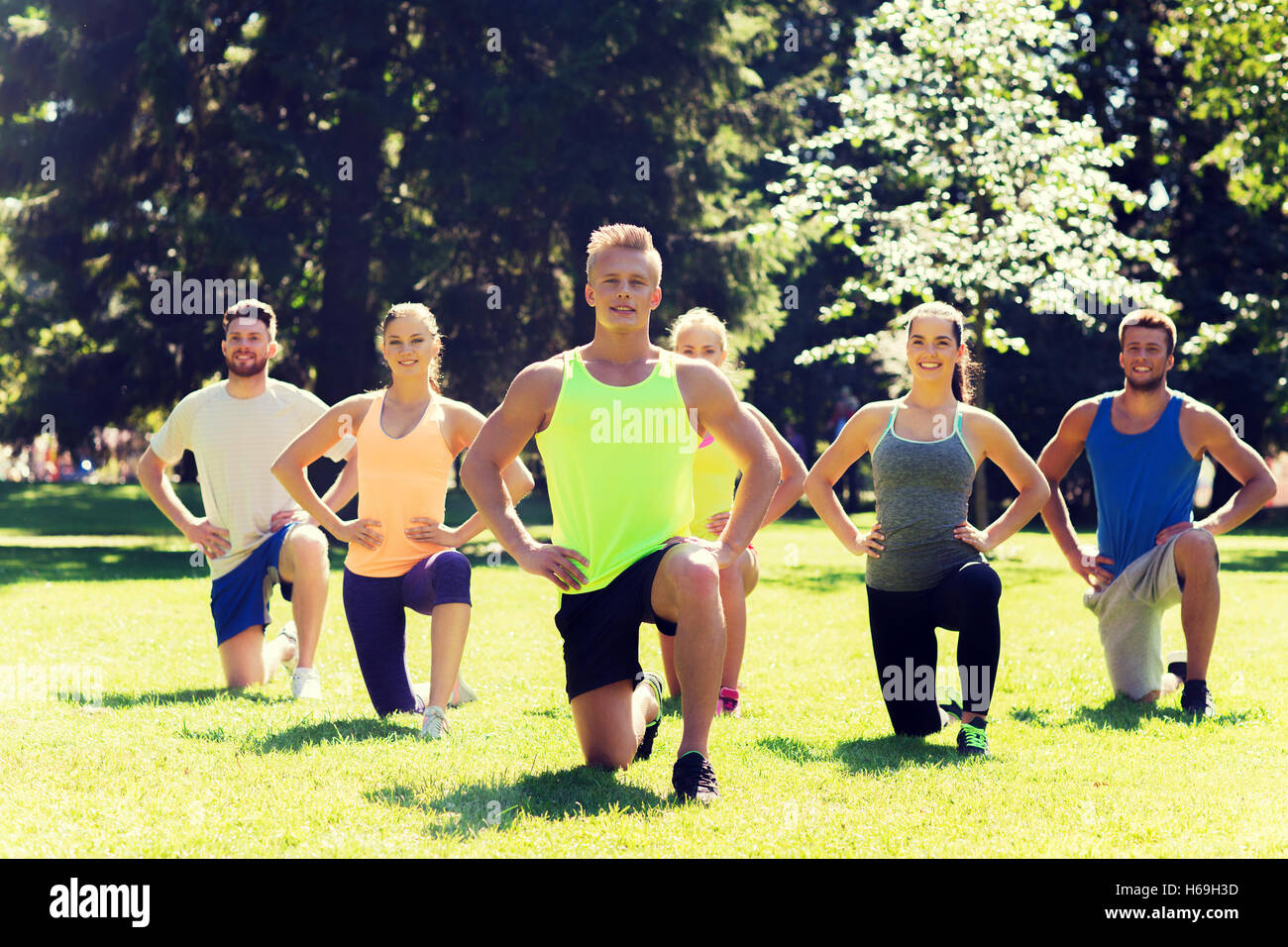 group of friends or sportsmen exercising outdoors Stock Photo - Alamy