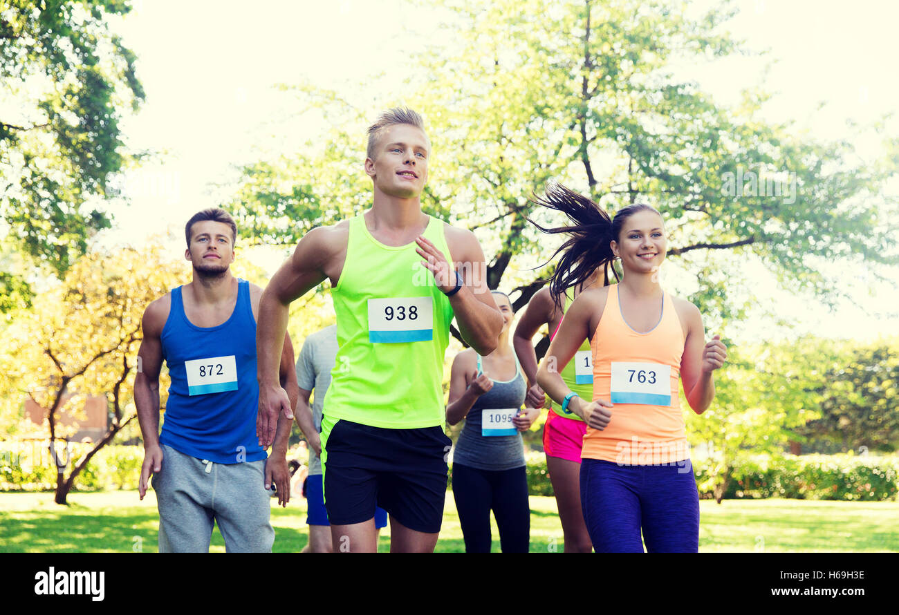 happy young sportsmen racing wit badge numbers Stock Photo - Alamy
