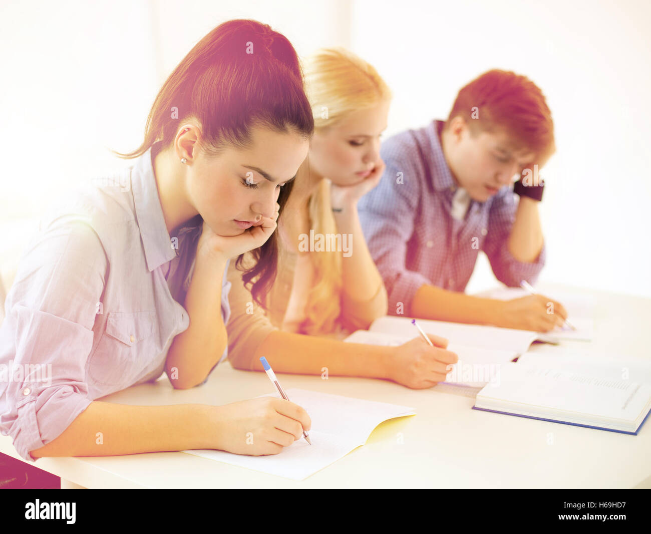 tired students with notebooks at school Stock Photo - Alamy