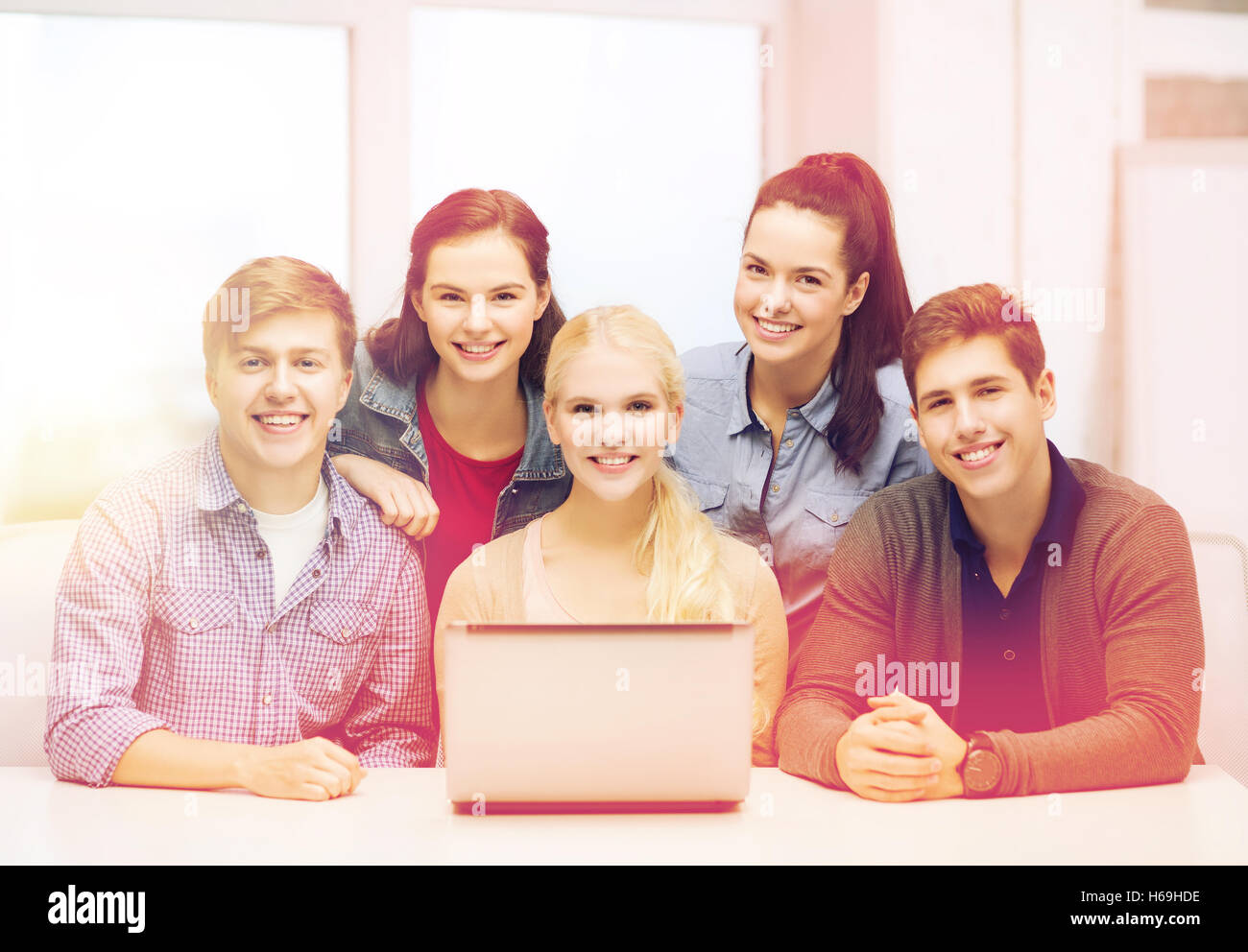smiling students with laptop at school Stock Photo - Alamy