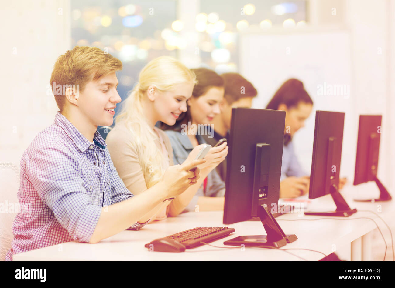 students with computer monitor and smartphones Stock Photo - Alamy