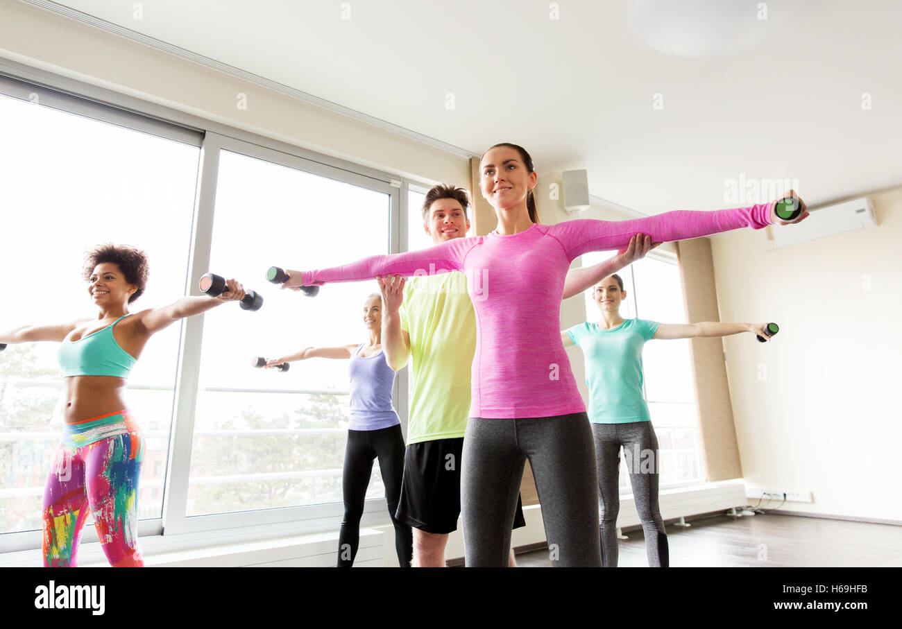 group of smiling people exercising with dumbbells Stock Photo - Alamy