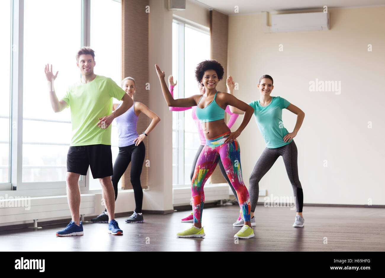 group of smiling people dancing in gym or studio Stock Photo - Alamy