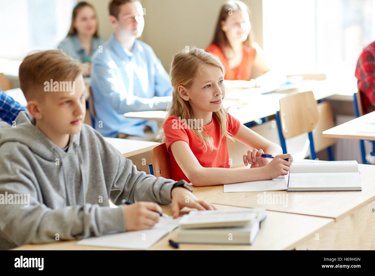group of students with notebooks at school lesson Stock Photo - Alamy