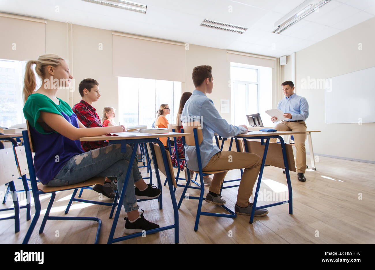group of students and teacher with papers or tests Stock Photo - Alamy