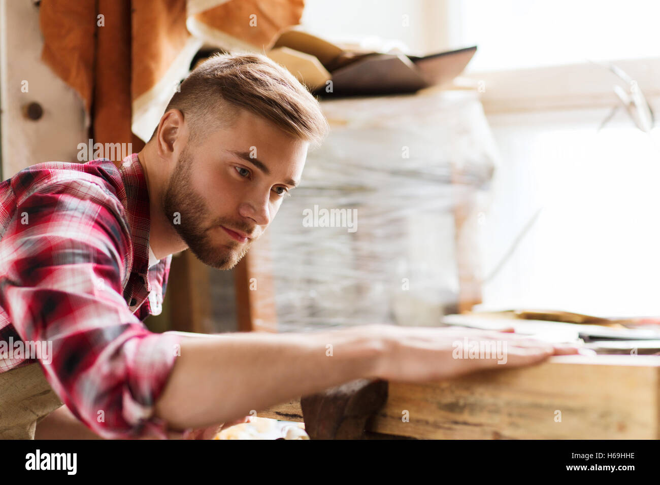 carpenter working with wood plank at workshop Stock Photo - Alamy