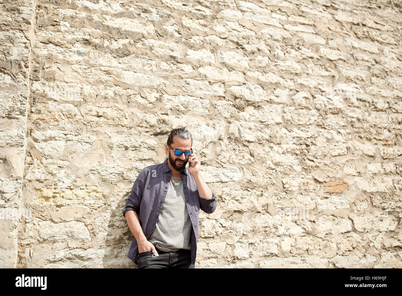 smiling man with smartphone calling on city street Stock Photo - Alamy