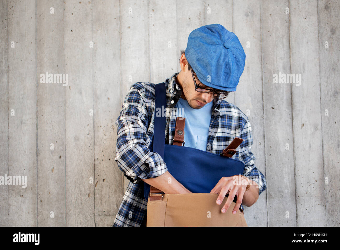 hipster man looking for something in his bag Stock Photo - Alamy