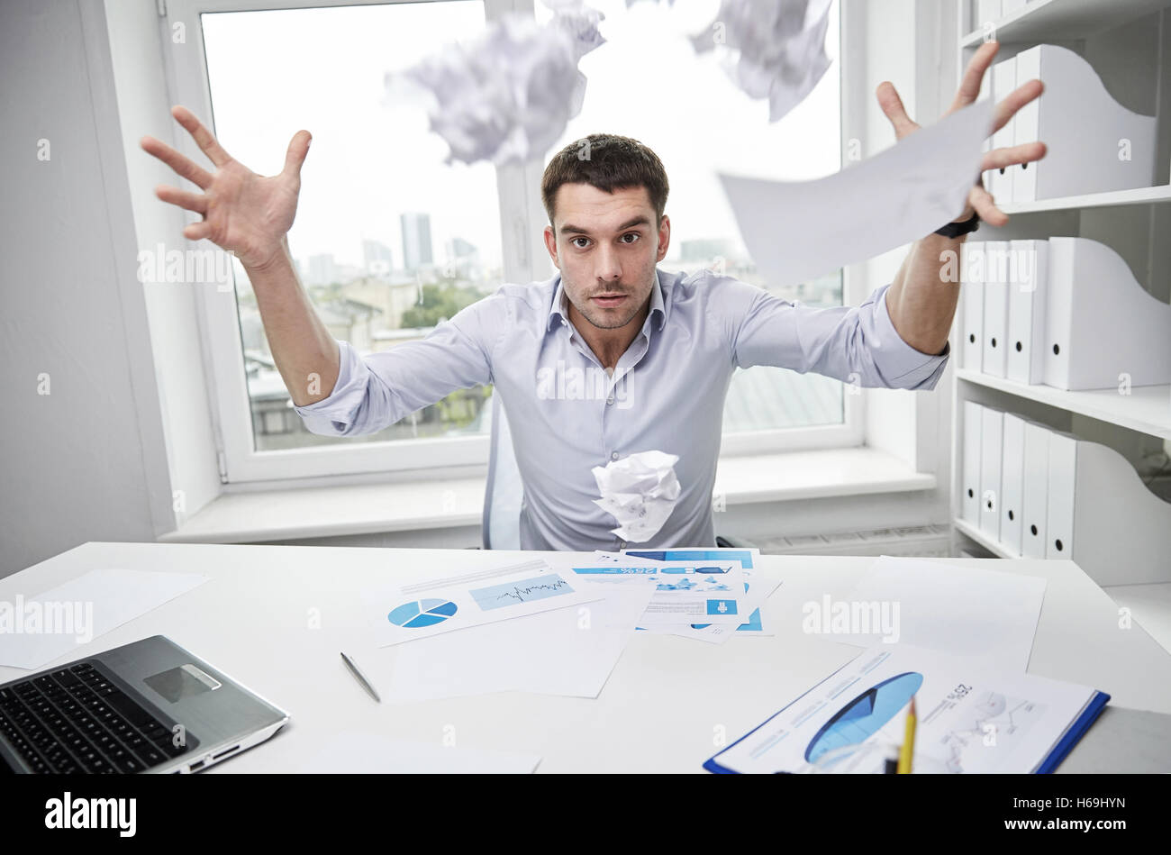 angry businessman throwing papers in office Stock Photo - Alamy