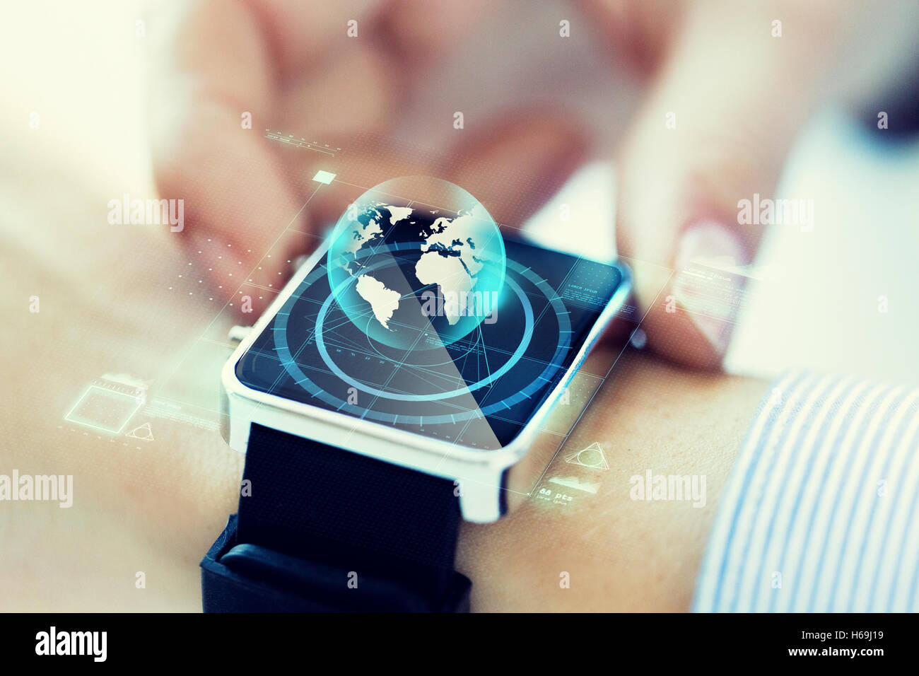 close up of hand with globe hologram on smartwatch Stock Photo - Alamy