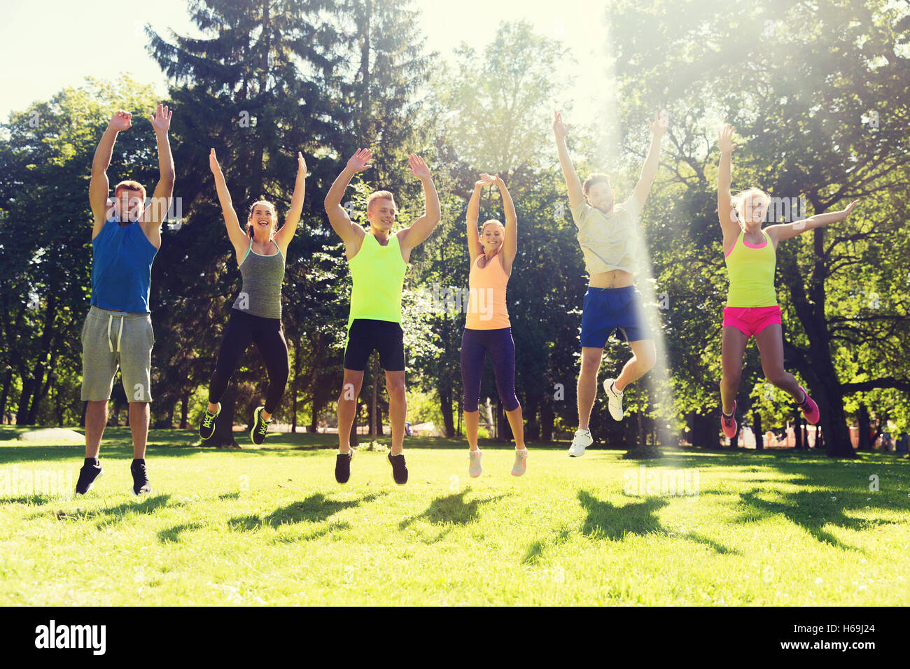 group of happy friends jumping high outdoors Stock Photo - Alamy