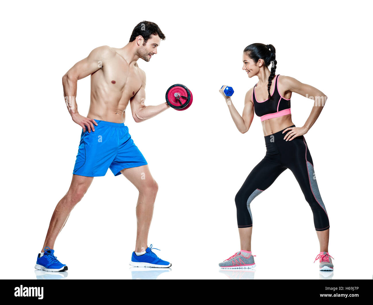 one caucasian couple man and woman exercising fitness weights exercises ...