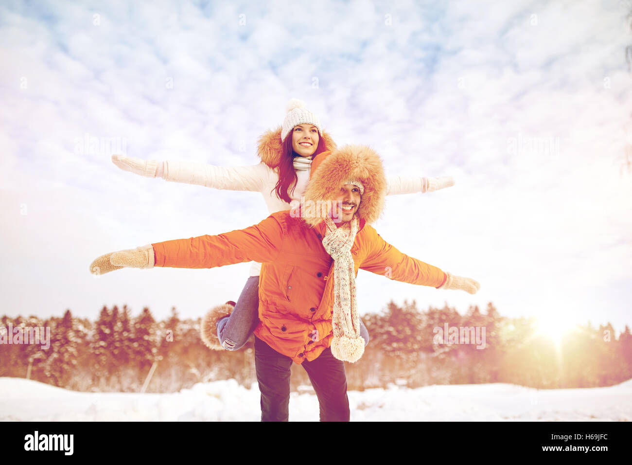 happy couple having fun over winter background Stock Photo - Alamy