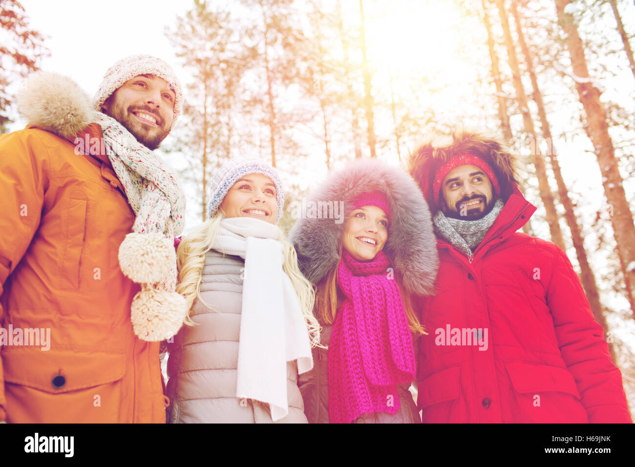 group of smiling men and women in winter forest Stock Photo - Alamy