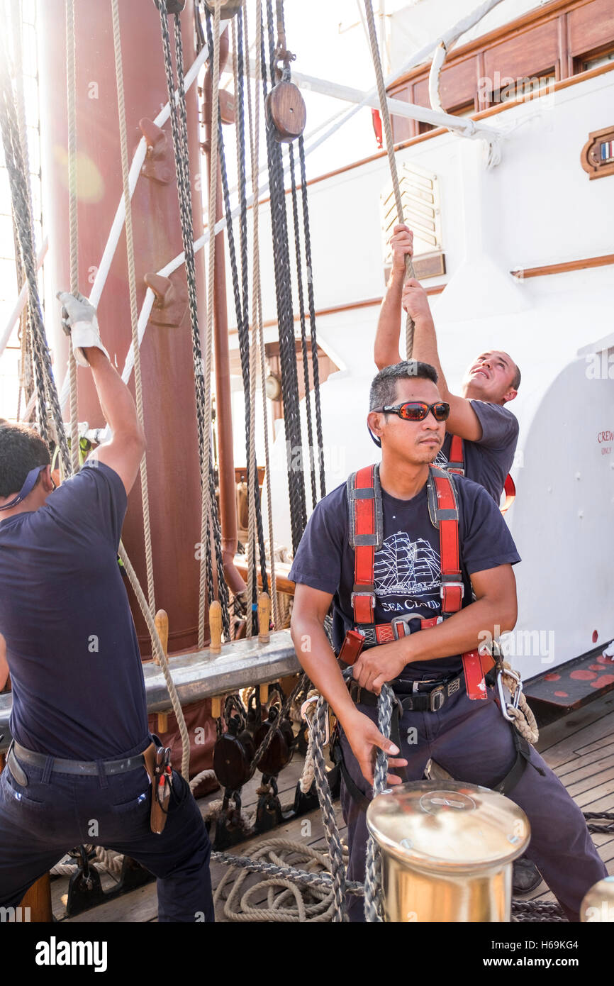 Sailors work to secure the sails on the historic S.Y. Sea Cloud tall ...