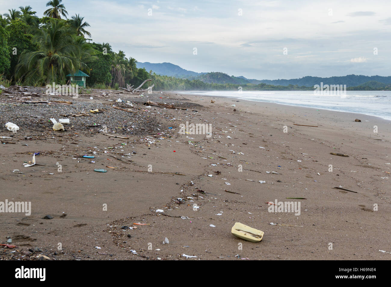 sad scene of environmental awareness of a beach full of trash after a ...