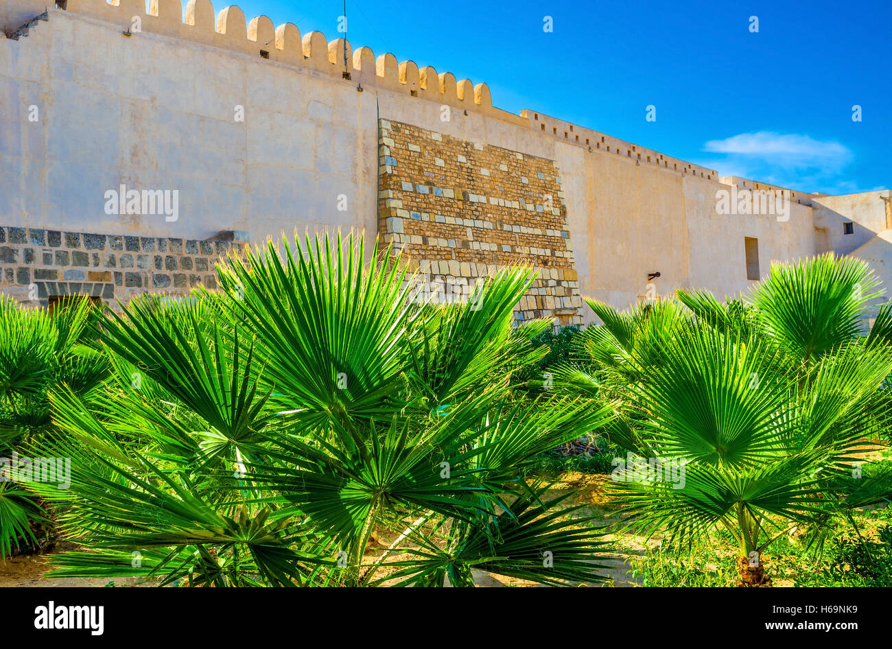 The high walls of Sousse Kasbah hide the shady garden, Tunisia Stock ...