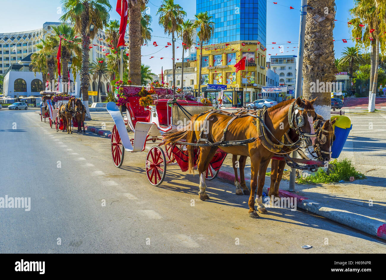 The colorful carriages wait for the tourists on the promenade Stock ...