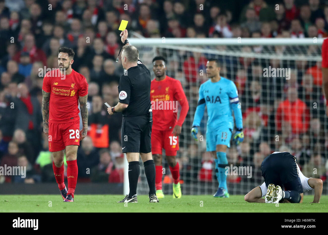 Liverpool's Danny Ings (left) is shown the yellow card by referee ...