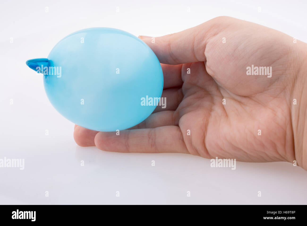 Hand holding a Colorful small balloon on a white background Stock Photo ...