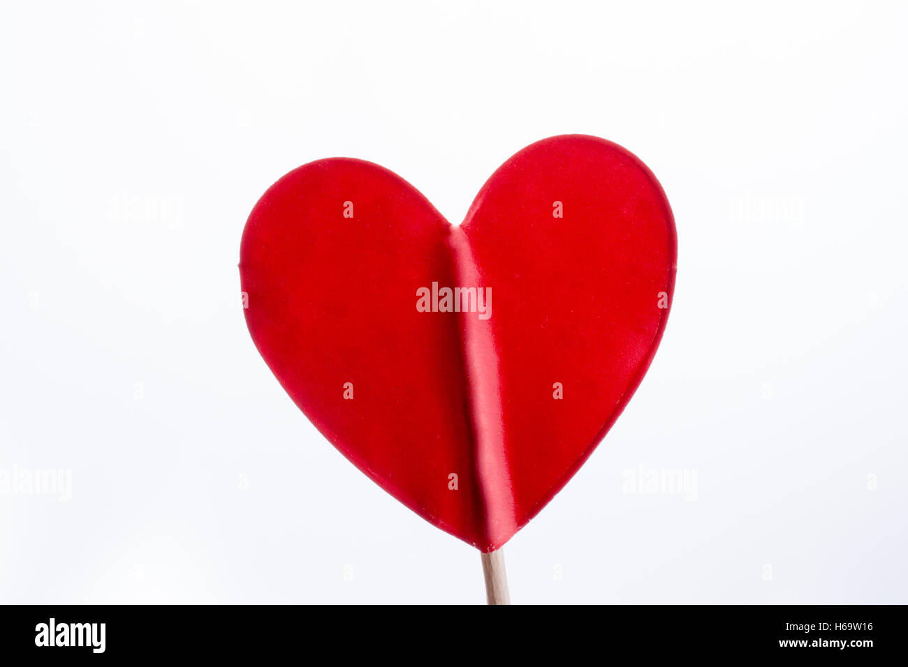 Little red color heart shape at the top of a stick Stock Photo - Alamy