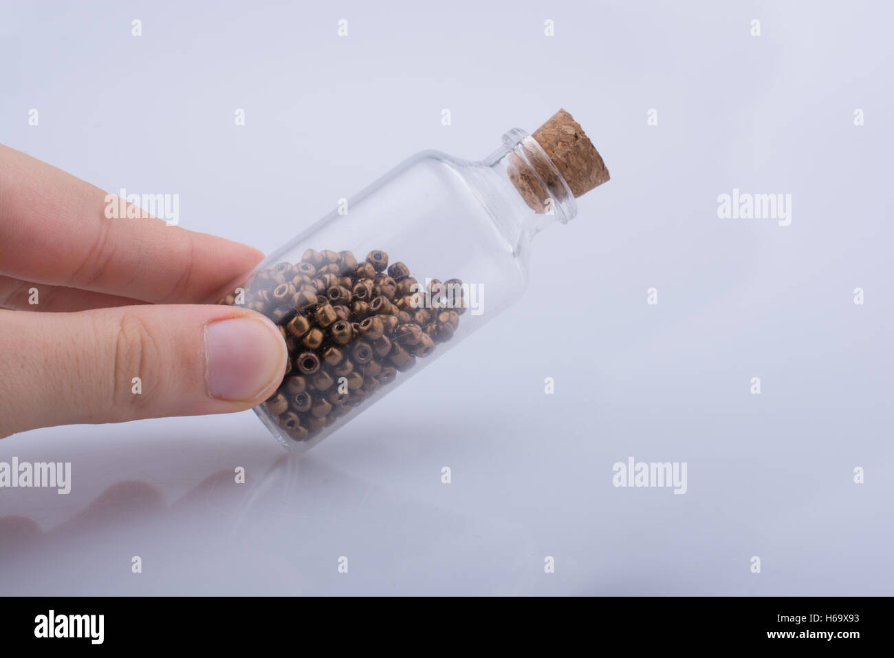 Little perfume glass bottle in hand on a white background Stock Photo ...