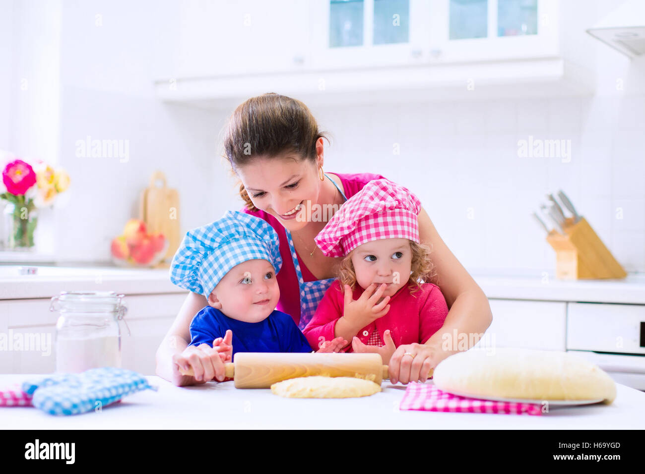 Kids and mother baking. Two children and parent cooking. Little girl ...