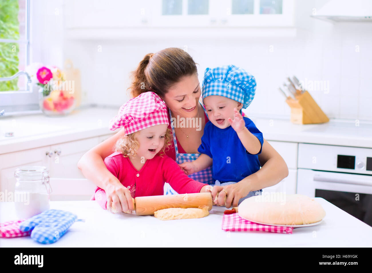 Kids and mother baking. Two children and parent cooking. Little girl ...