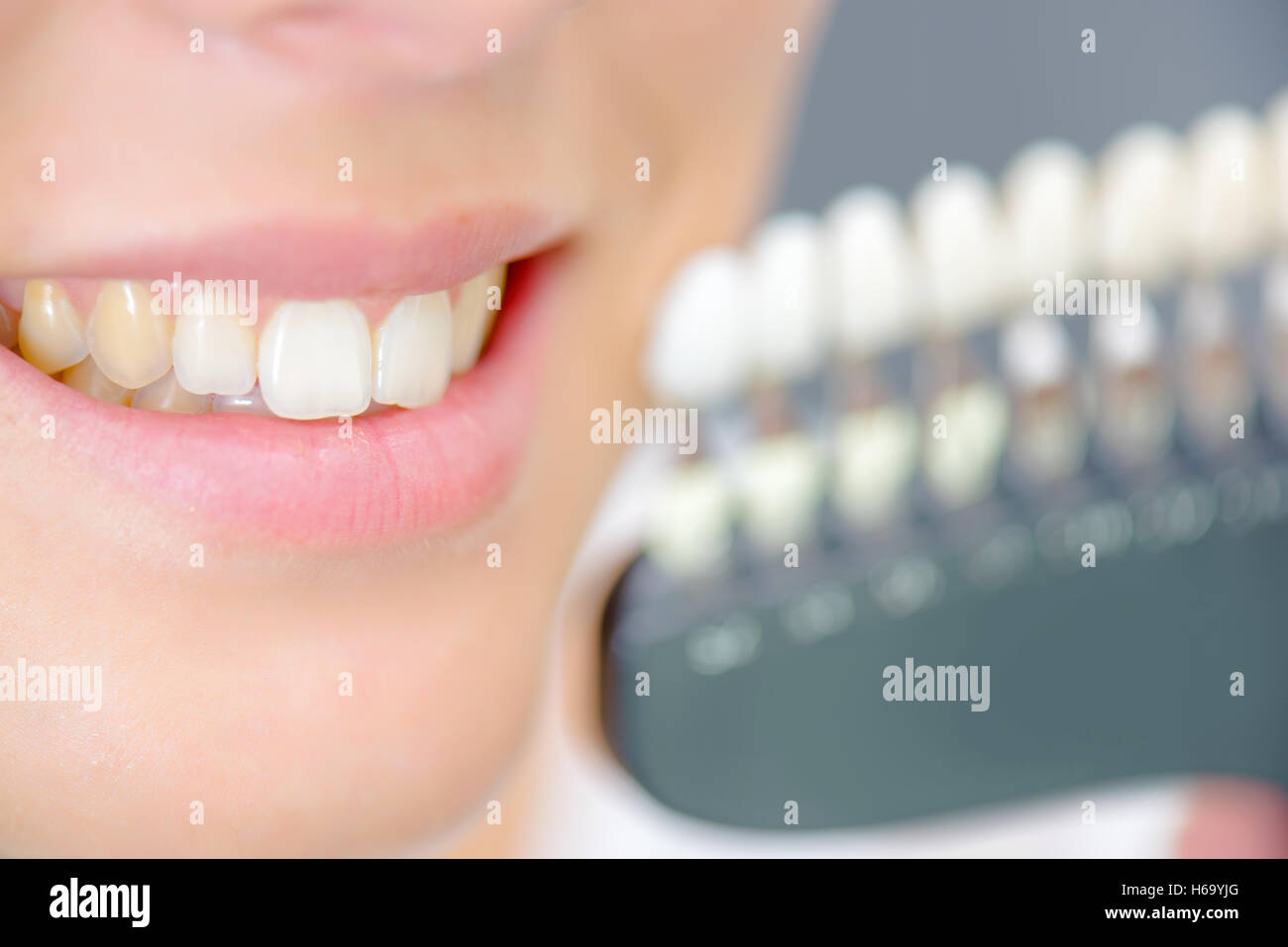 Lady smiling next to teeth samples Stock Photo - Alamy