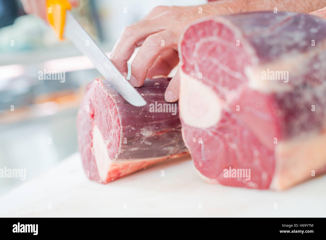 Butcher slicing some beef Stock Photo - Alamy