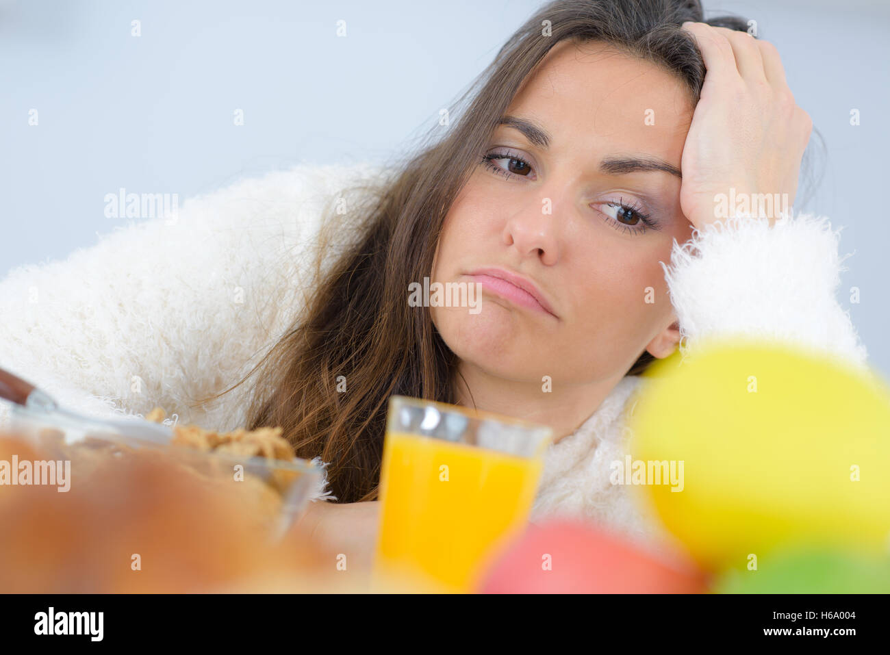 Grumpy woman with orange juice Stock Photo - Alamy
