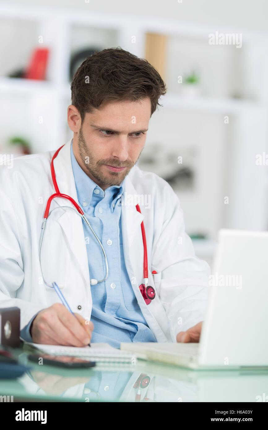 the doctor writing in office Stock Photo - Alamy