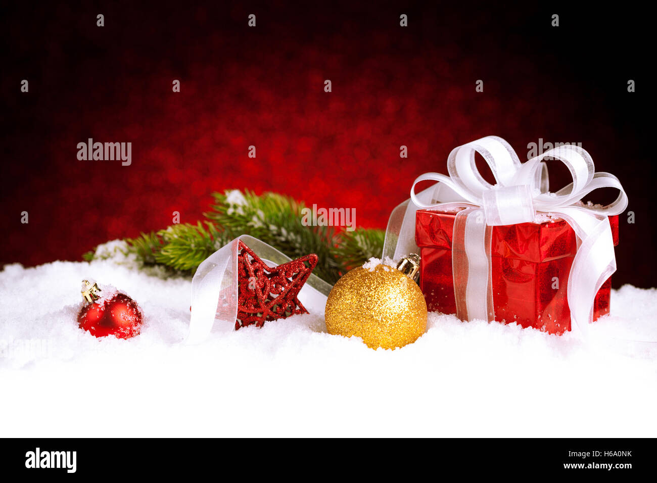 Christmas gift with decoration on snow Stock Photo - Alamy