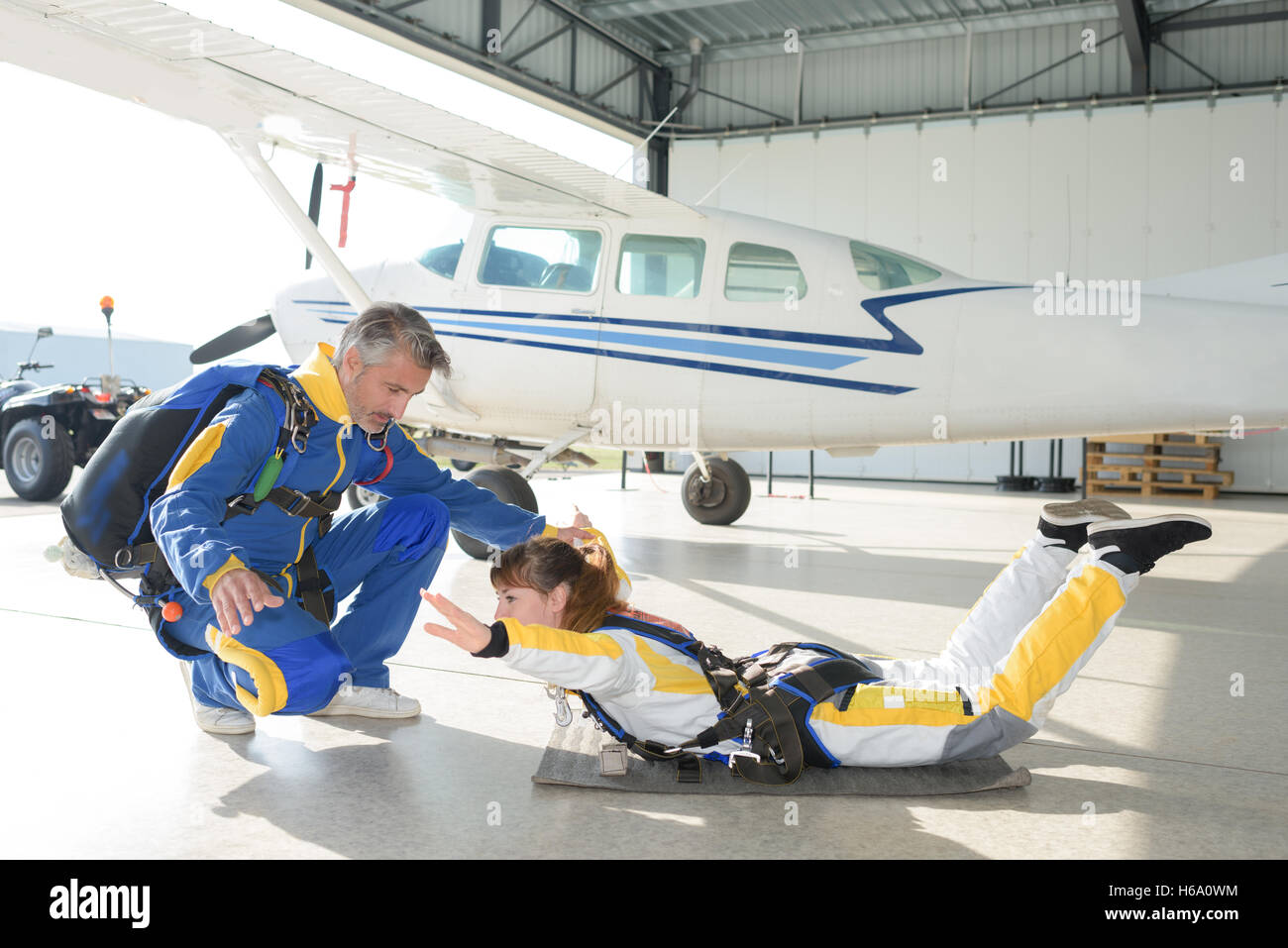 Woman practicing position for parachute jump Stock Photo - Alamy