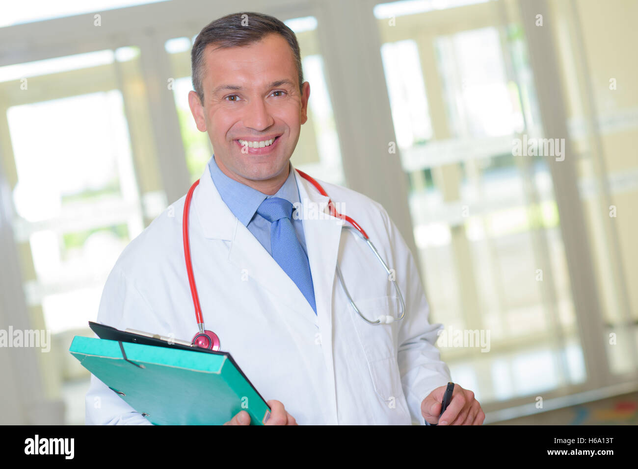 Doctor holding files Stock Photo - Alamy
