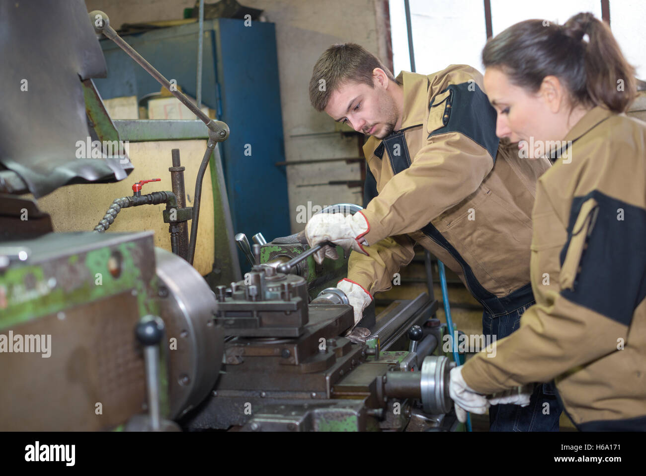 employees using industrial machinery at factory Stock Photo - Alamy