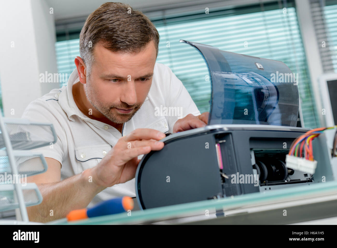 Man repairing printer Stock Photo - Alamy
