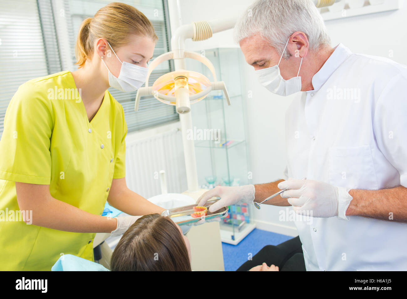Busy dentist with a patient Stock Photo - Alamy