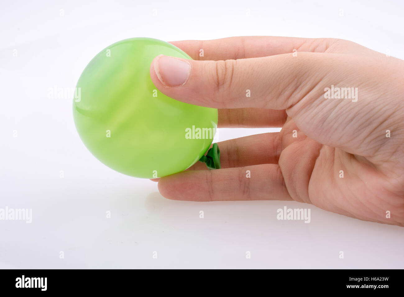 Hand holding a Colorful small balloon on a white background Stock Photo ...
