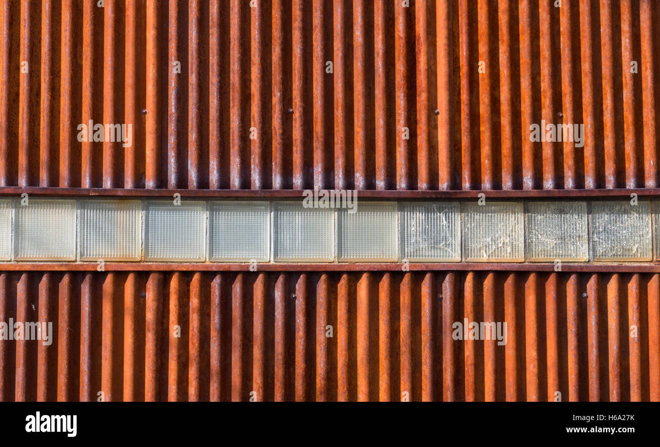 Old, Rusty Corrugated Metal Wall with a Row of Glass Bricks, Some ...