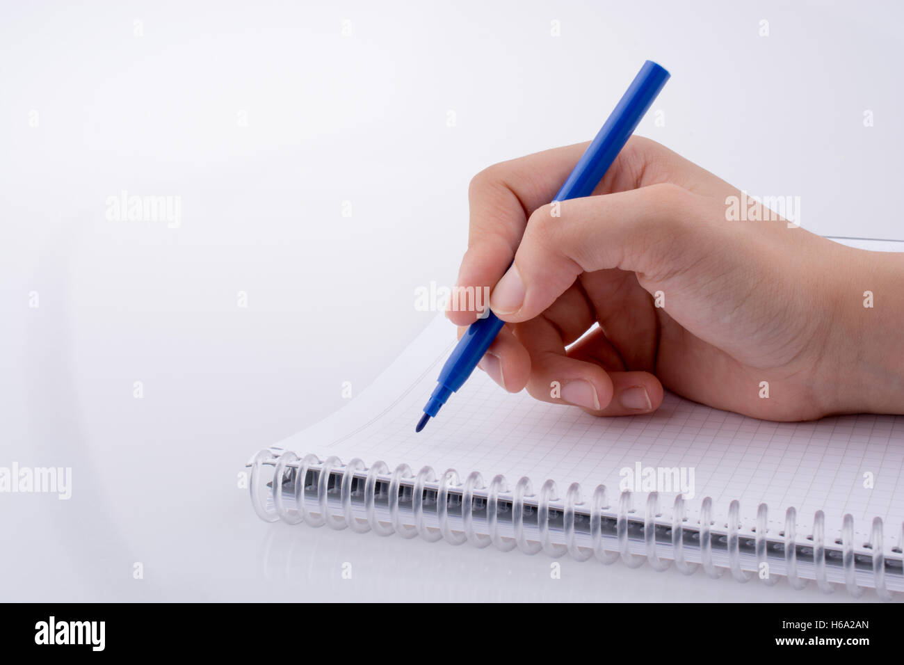 Hand writing on a Notebook with a pen on a white background Stock Photo ...