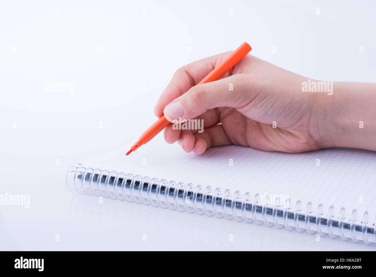 Hand writing on a Notebook with a pen on a white background Stock Photo ...
